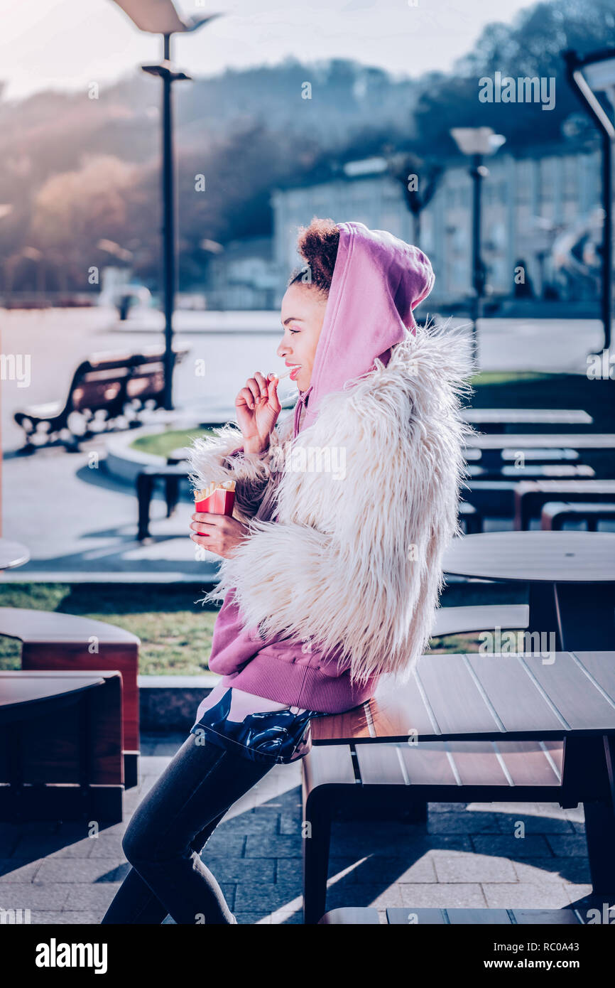 Attractive stylish girl sitting in semi position Stock Photo - Alamy