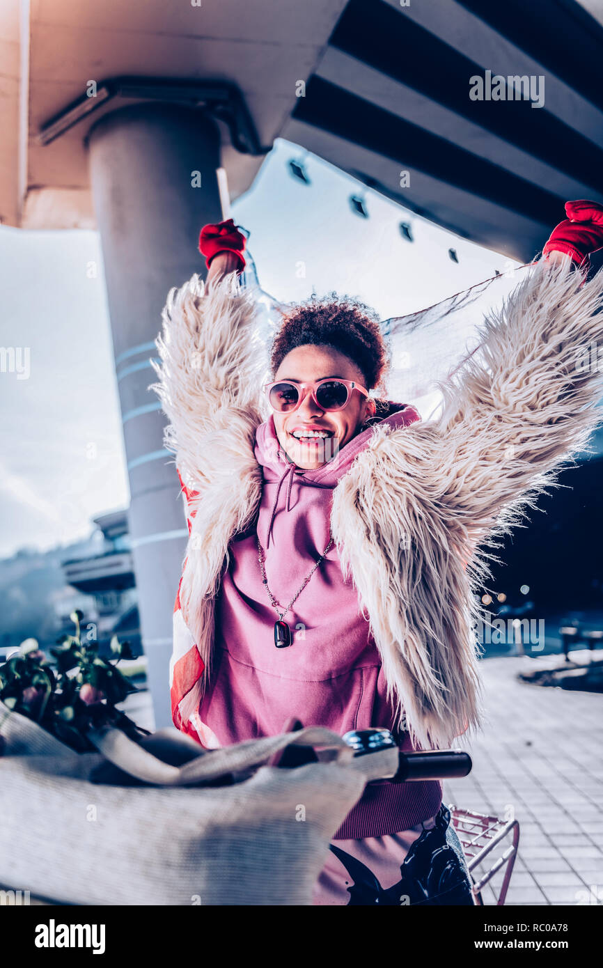 Stylish international girl raising both arms with flag Stock Photo - Alamy