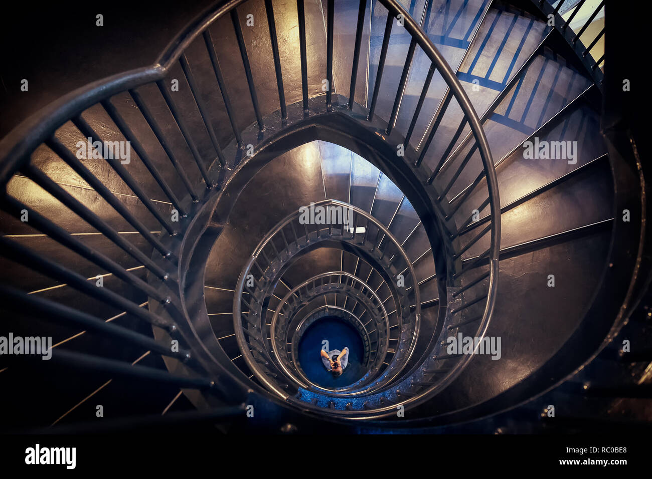 Spiral staircase top view with a photographer staying downstairs Stock ...