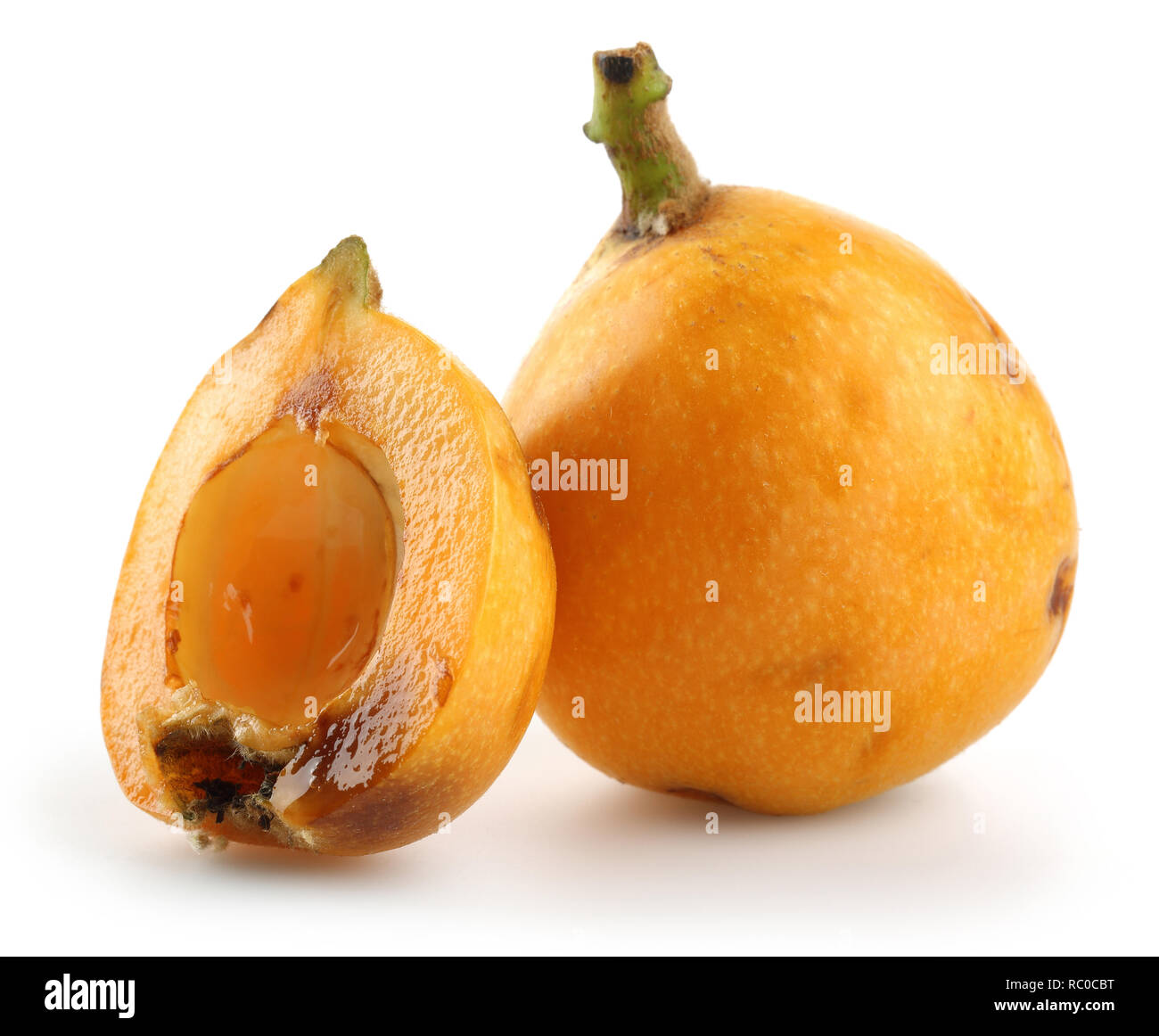 Ripe loquat and half isolated on white background Stock Photo - Alamy