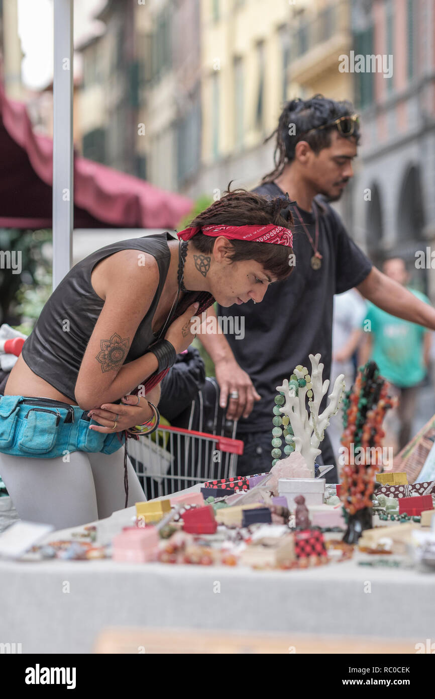 Young travellers shopping at city market stall, Pisa, Tuscany, Italy ...