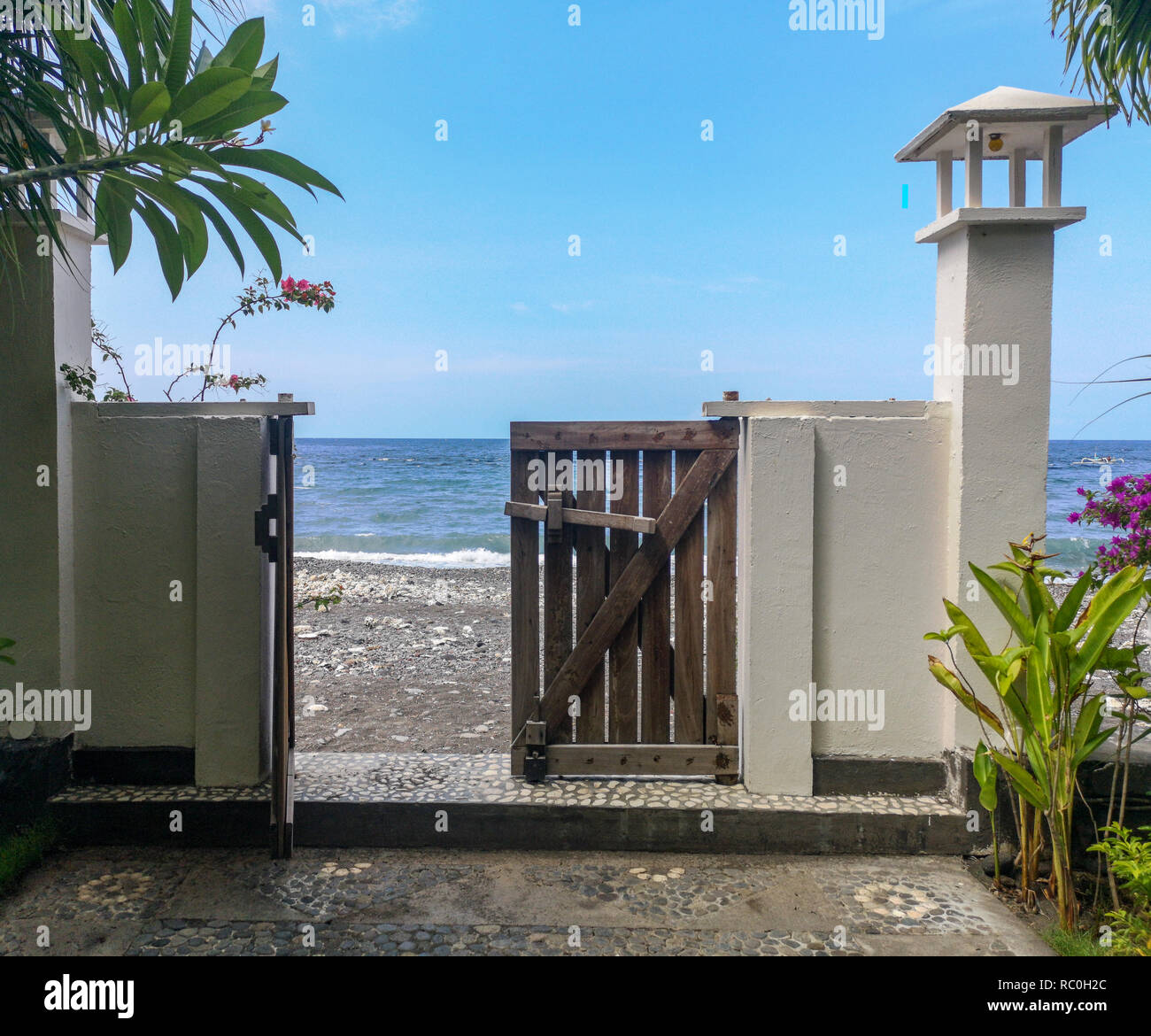 Wooden gate open towards the Amed Beach and the Bali Sea. Brown gate ...