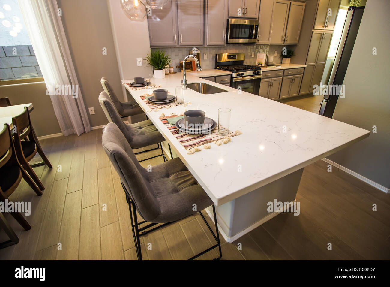 Kitchen Granite Counter With Stools And Place Settings Stock Photo - Alamy