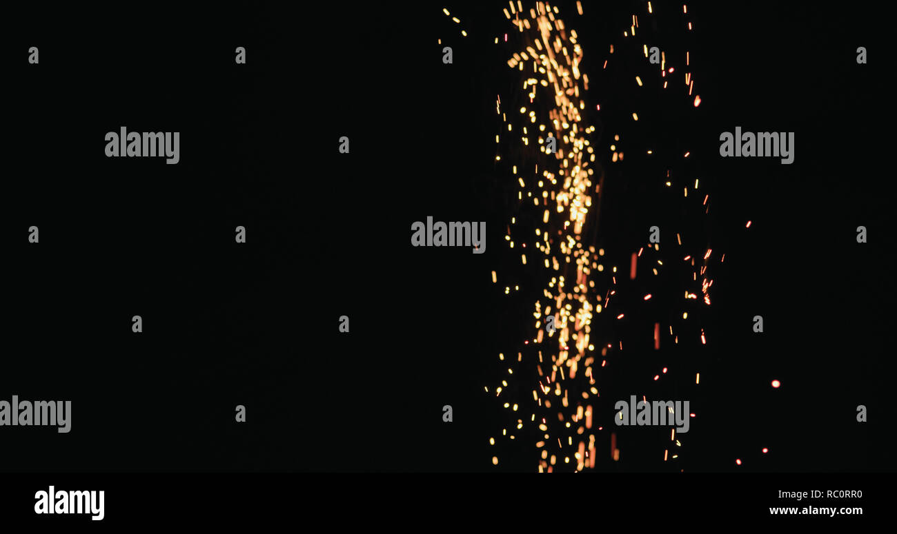 hot sparks slowly falling from above black background, wide photo Stock ...