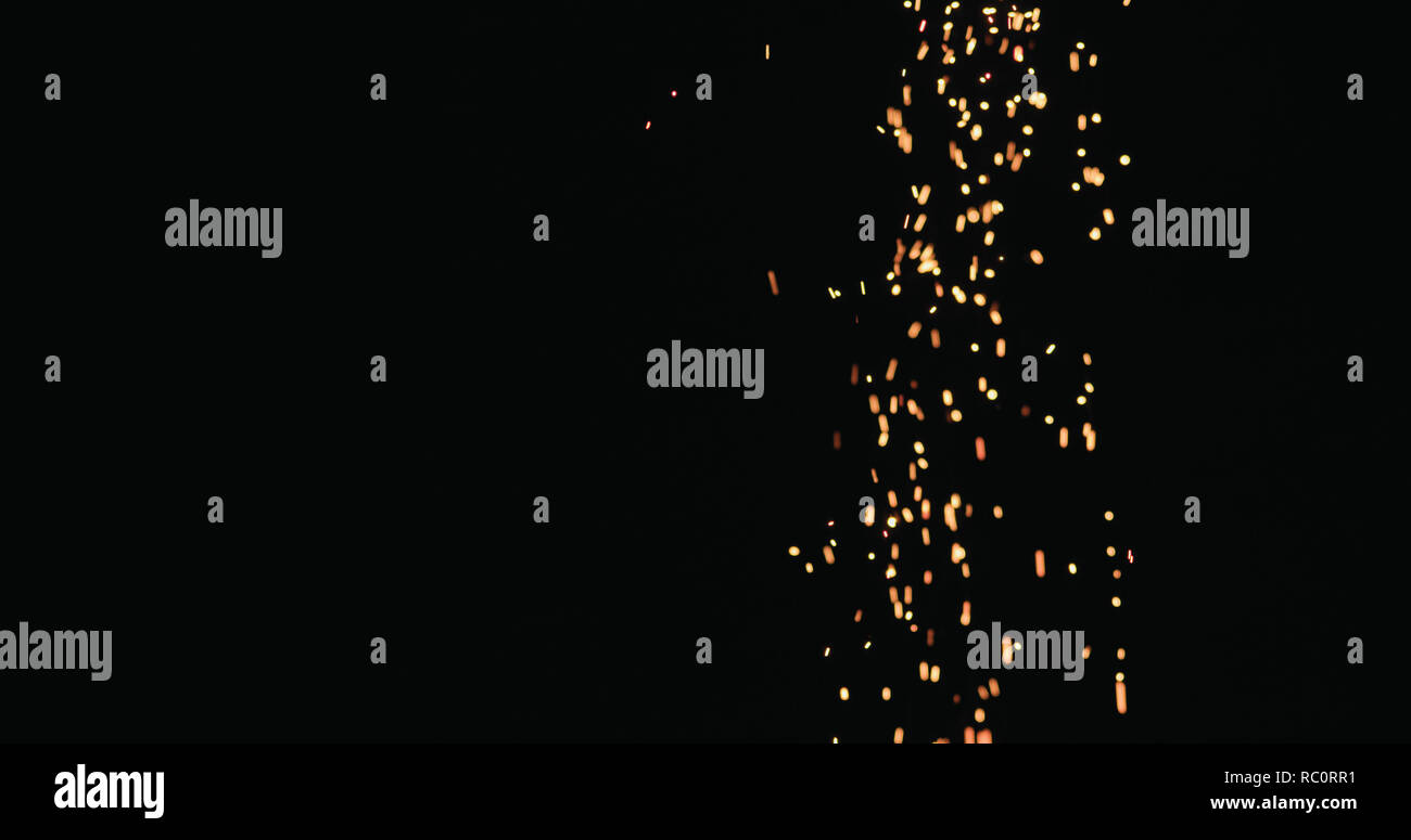 hot sparks slowly falling from above black background, wide photo Stock ...