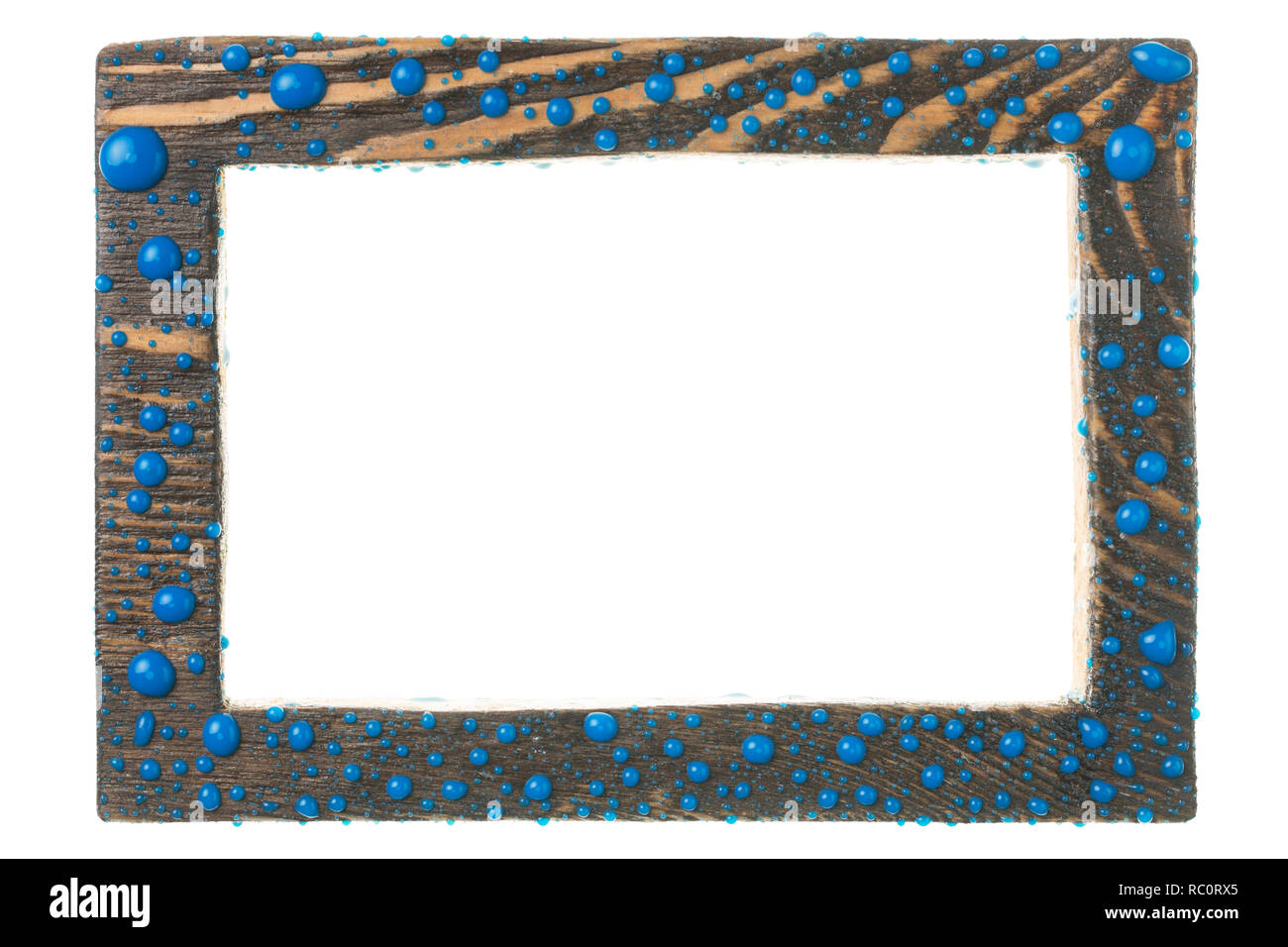 Beautiful wooden frame in drops of blue paint. Isolated on white ...