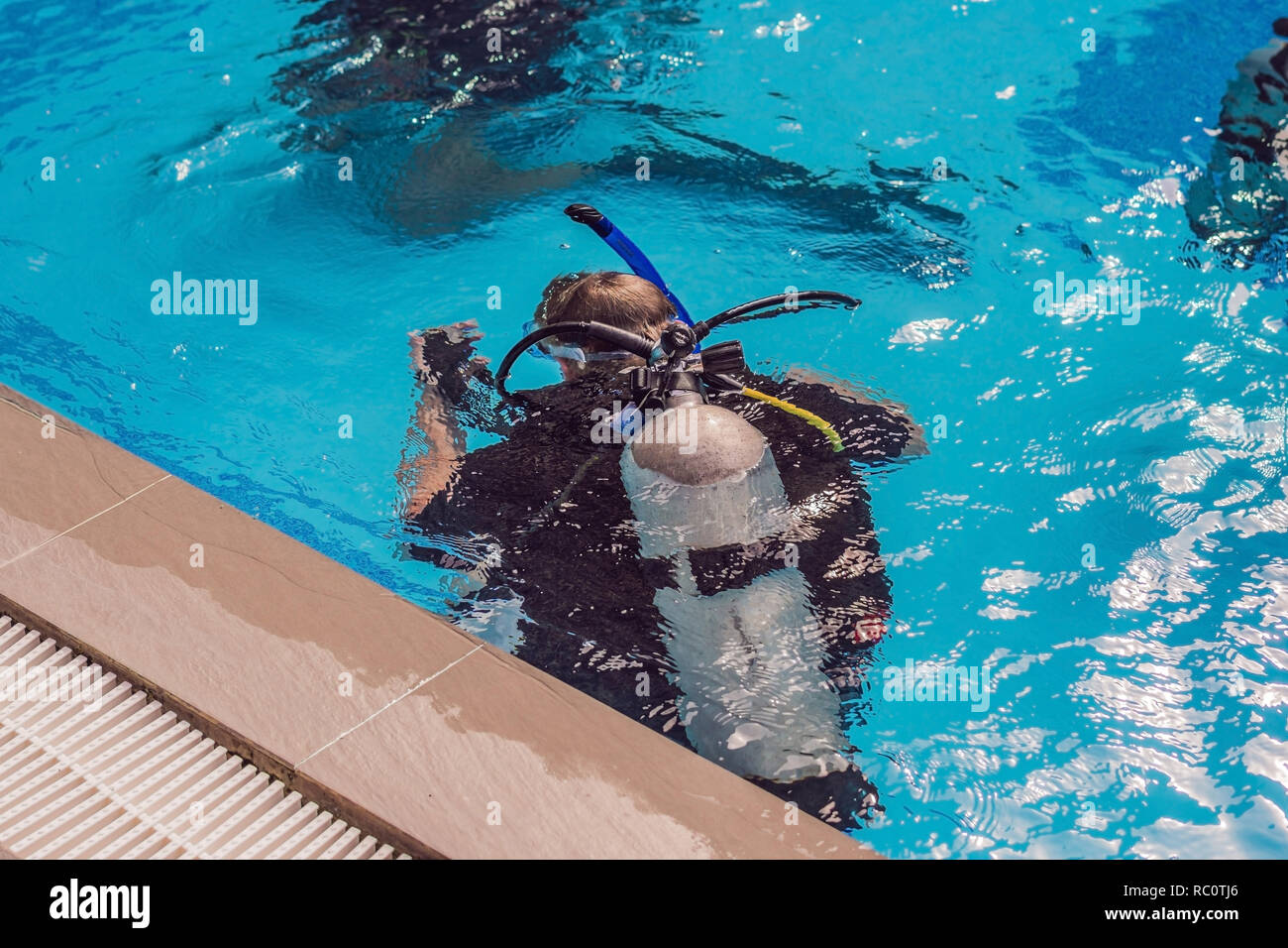 Diving instructor and students. Instructor teaches students to dive ...