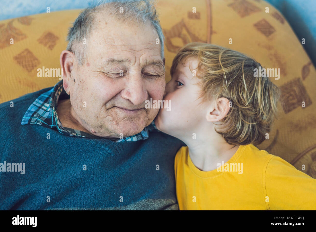 portrait of a Happy boy kissing happy granddad at home Stock Photo - Alamy