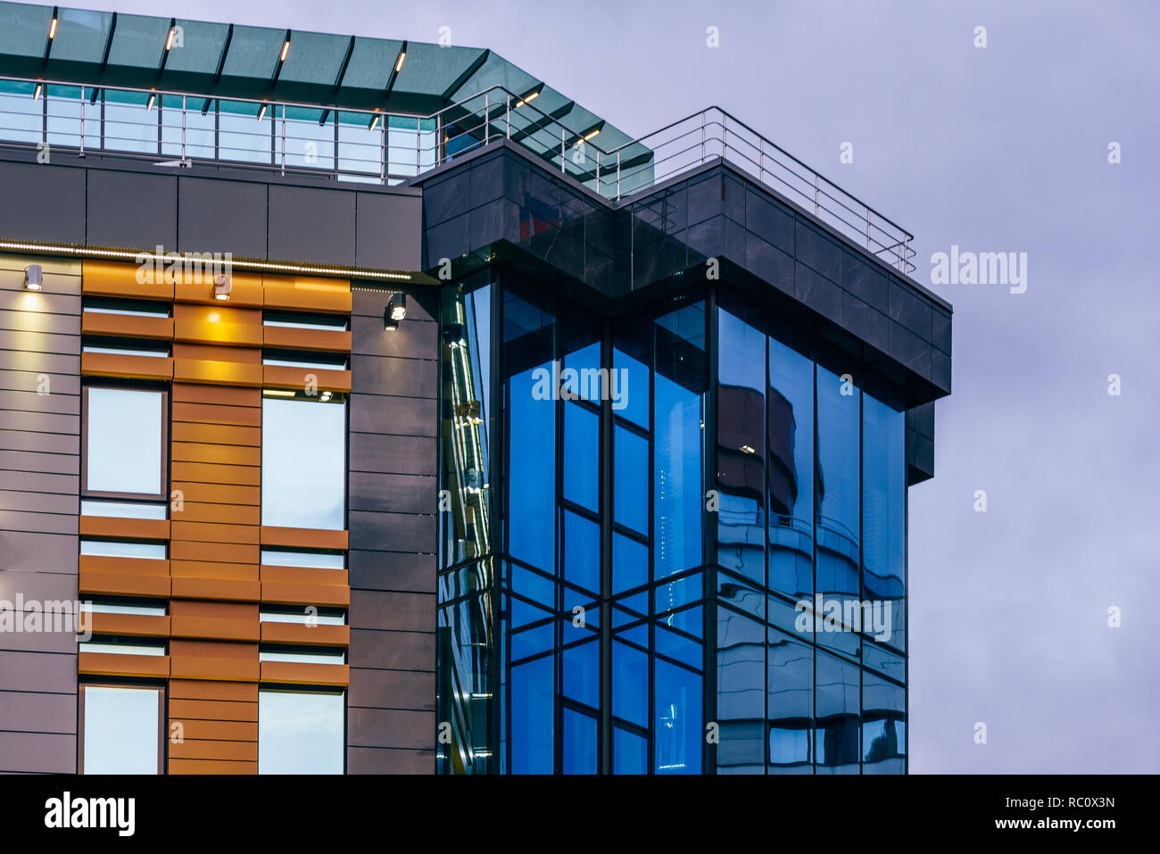 Modern high-rise office building with a glass facade at overcast ...