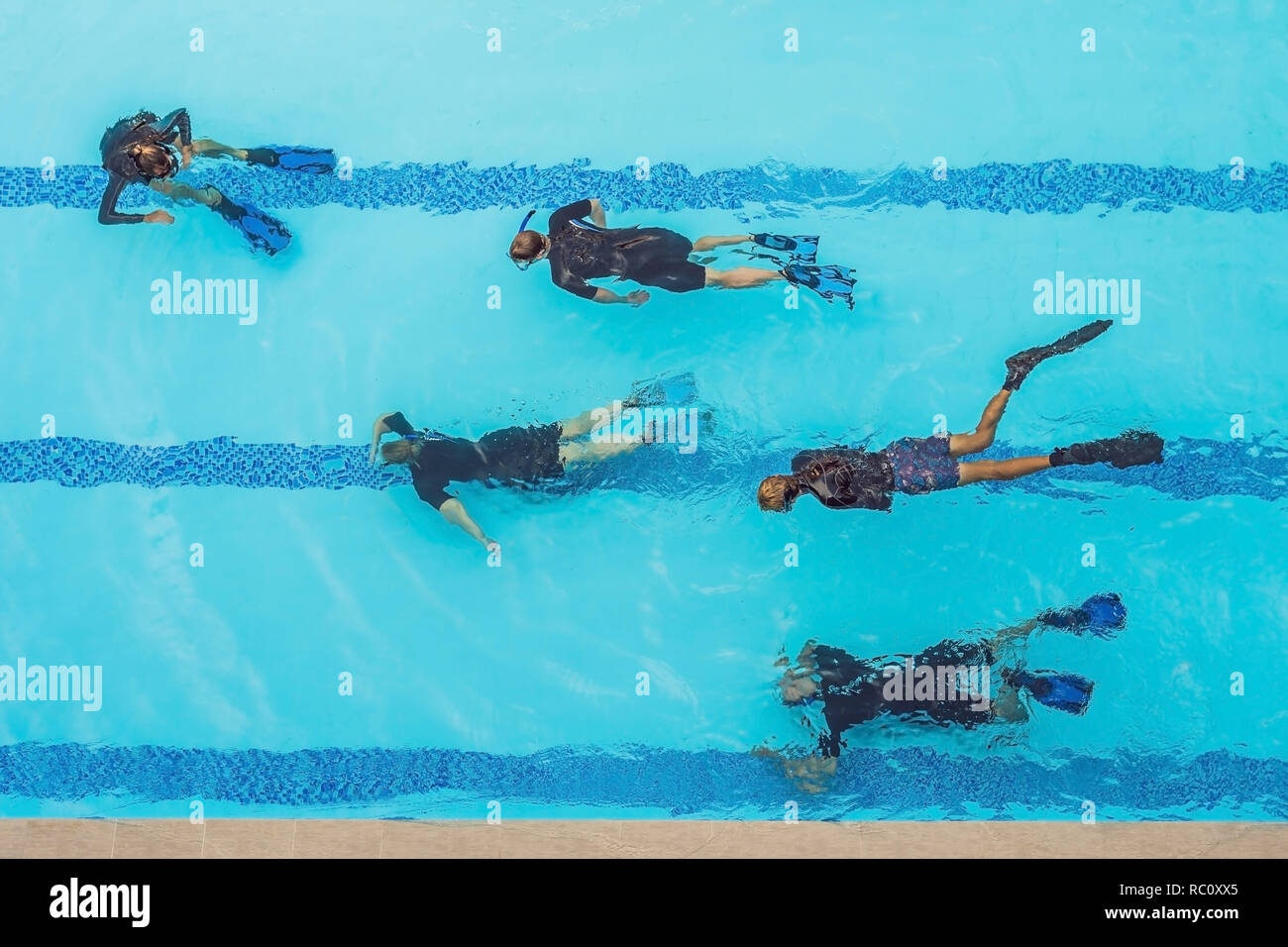 Diving instructor and students. Instructor teaches students to dive ...