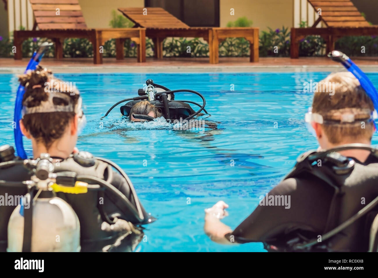 Diving instructor and students. Instructor teaches students to dive ...