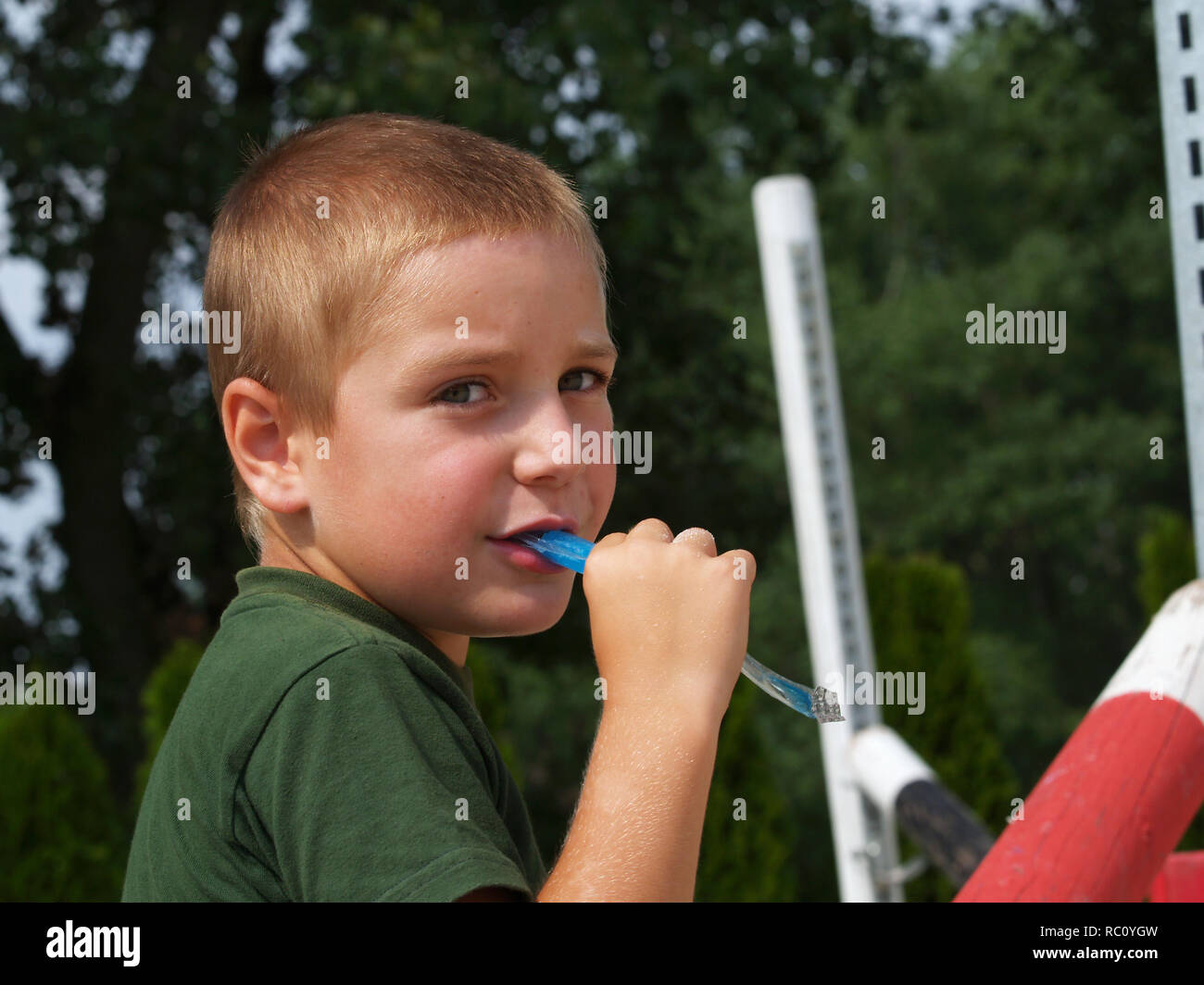 Little boy eating blue icecream Stock Photo - Alamy