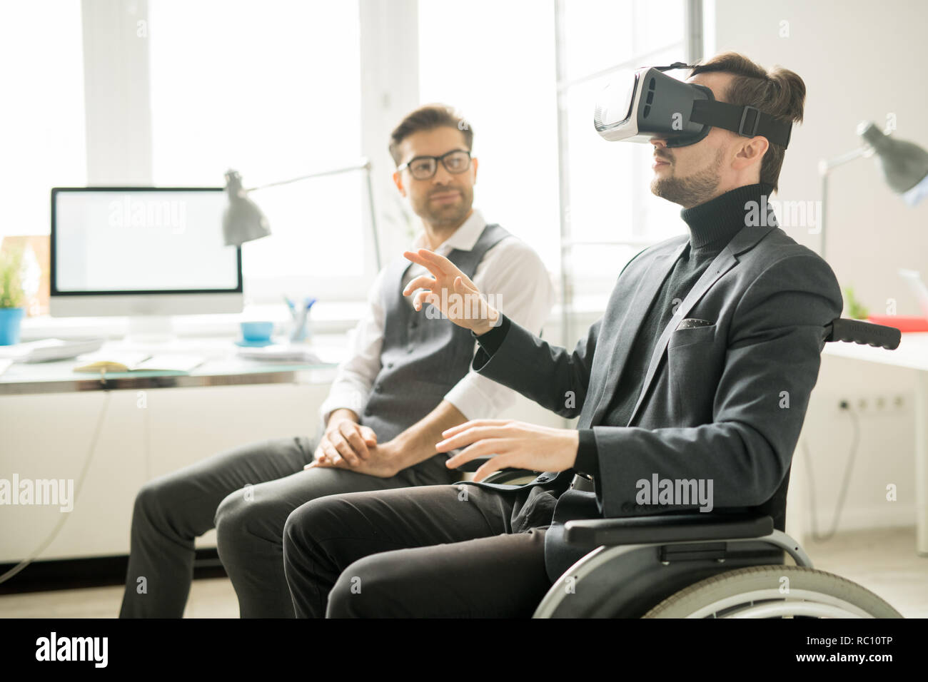 Disabled man testing virtual reality Stock Photo - Alamy