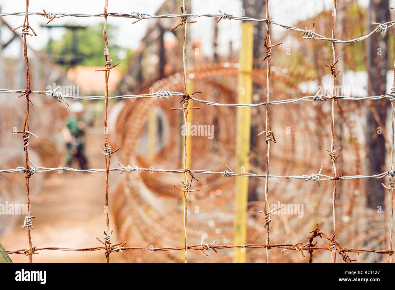 Barbed wire, a fence in prison and the silhouette of a prison guard on ...