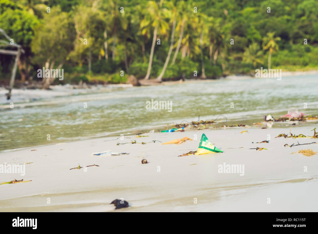 Garbage on a beautiful beach with white sand. Contamination of the ...