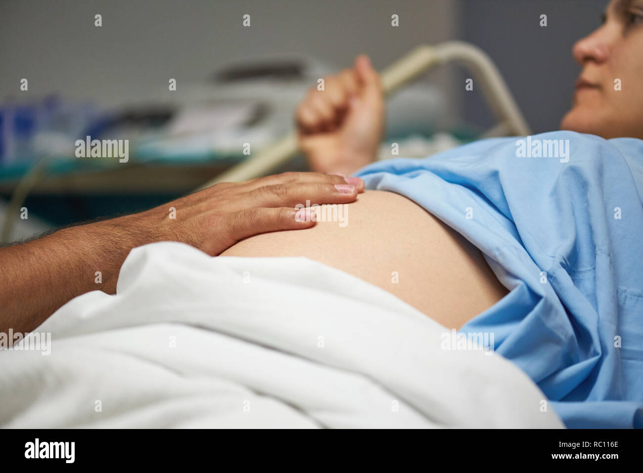 Doctor hand on woman belly close-up view Stock Photo - Alamy