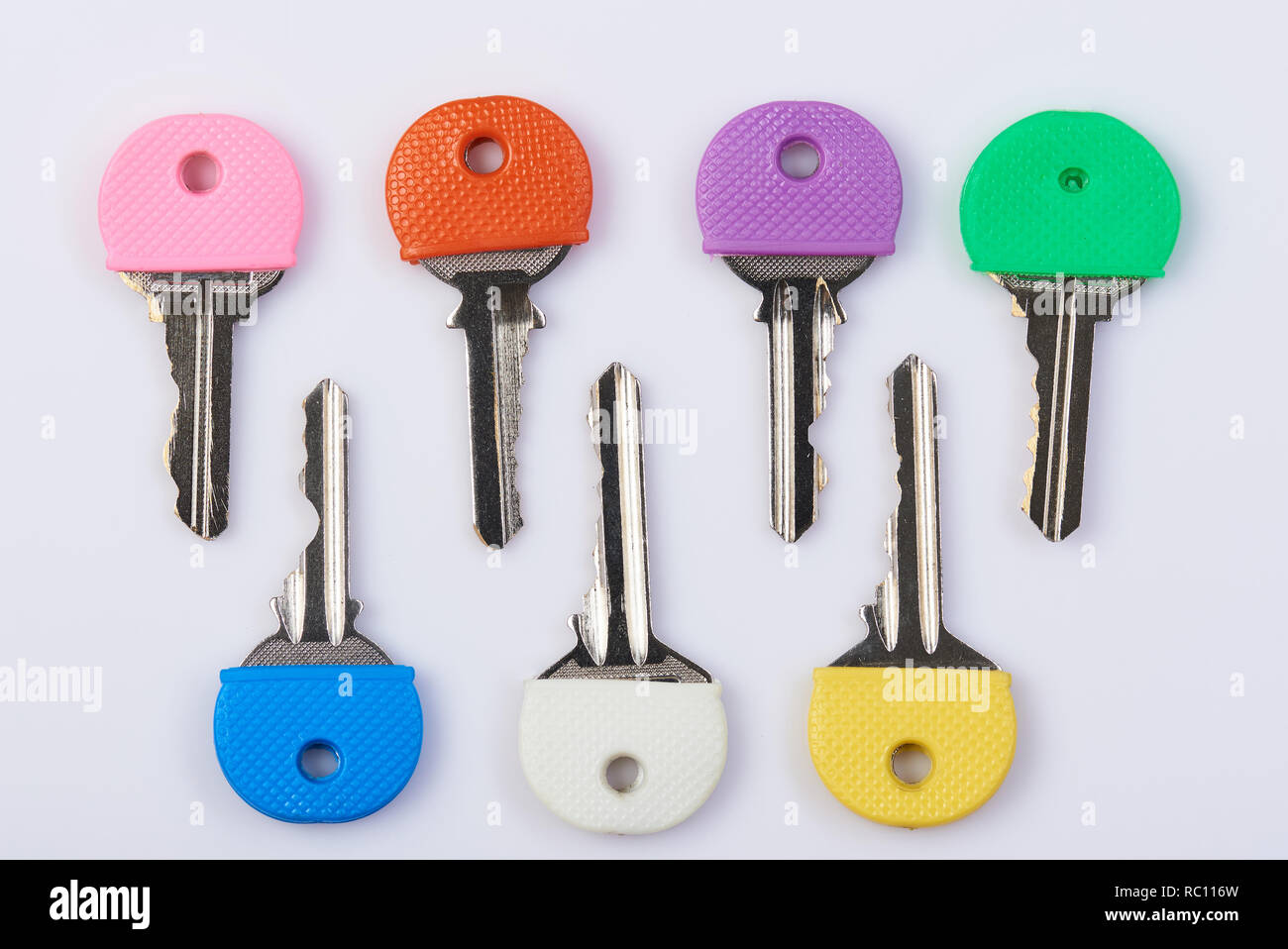 Colorful lock keys isolated on white background Stock Photo - Alamy