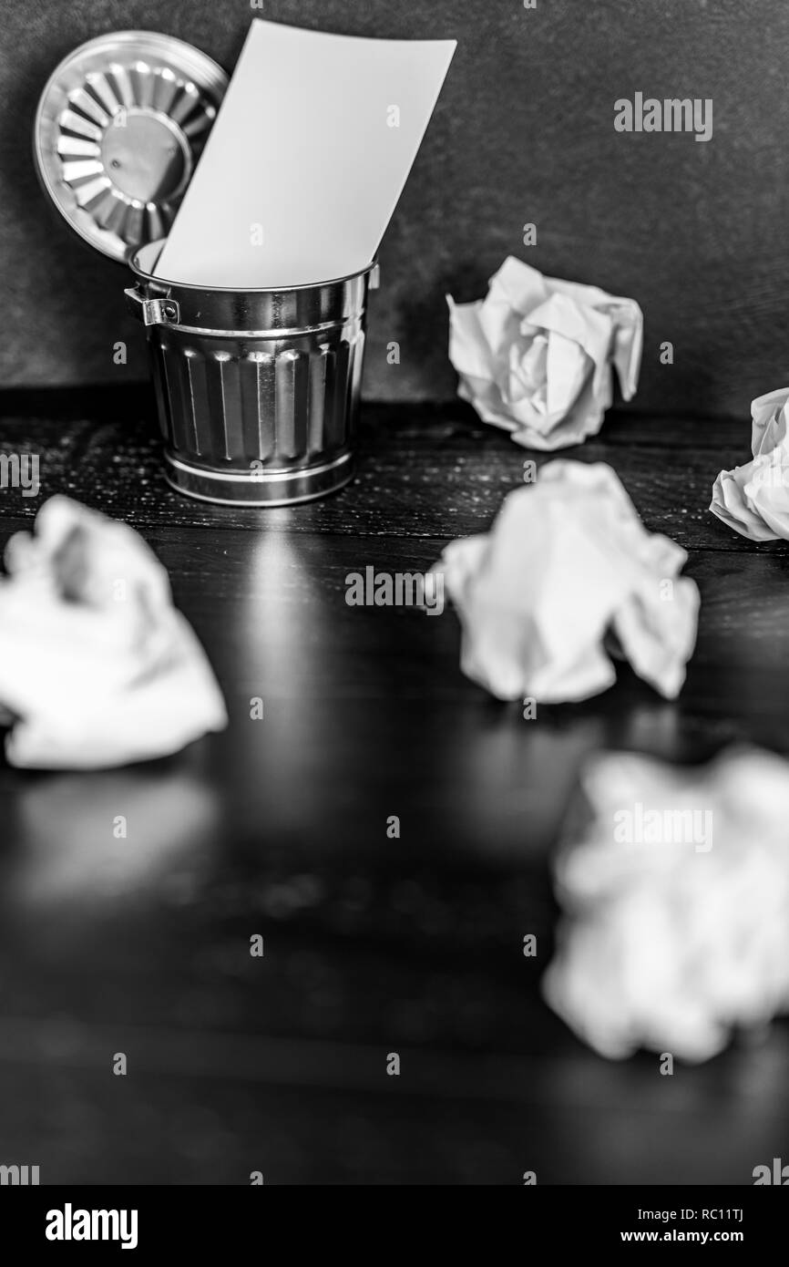 garbage bin on desk setting with empty notepad and scrunched paper ...