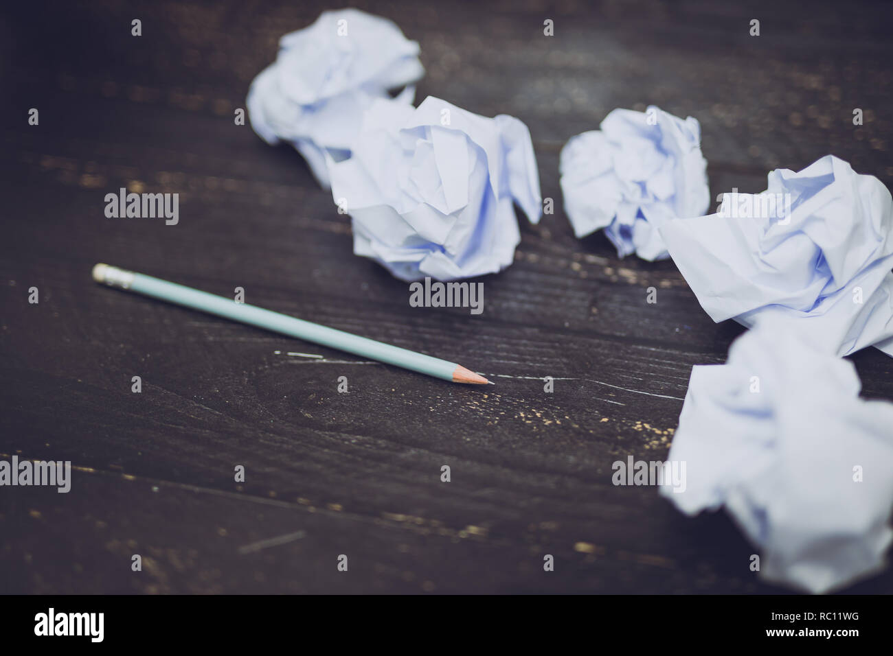 pencil on desk and scrunched paper balls, concept of drafting and ...