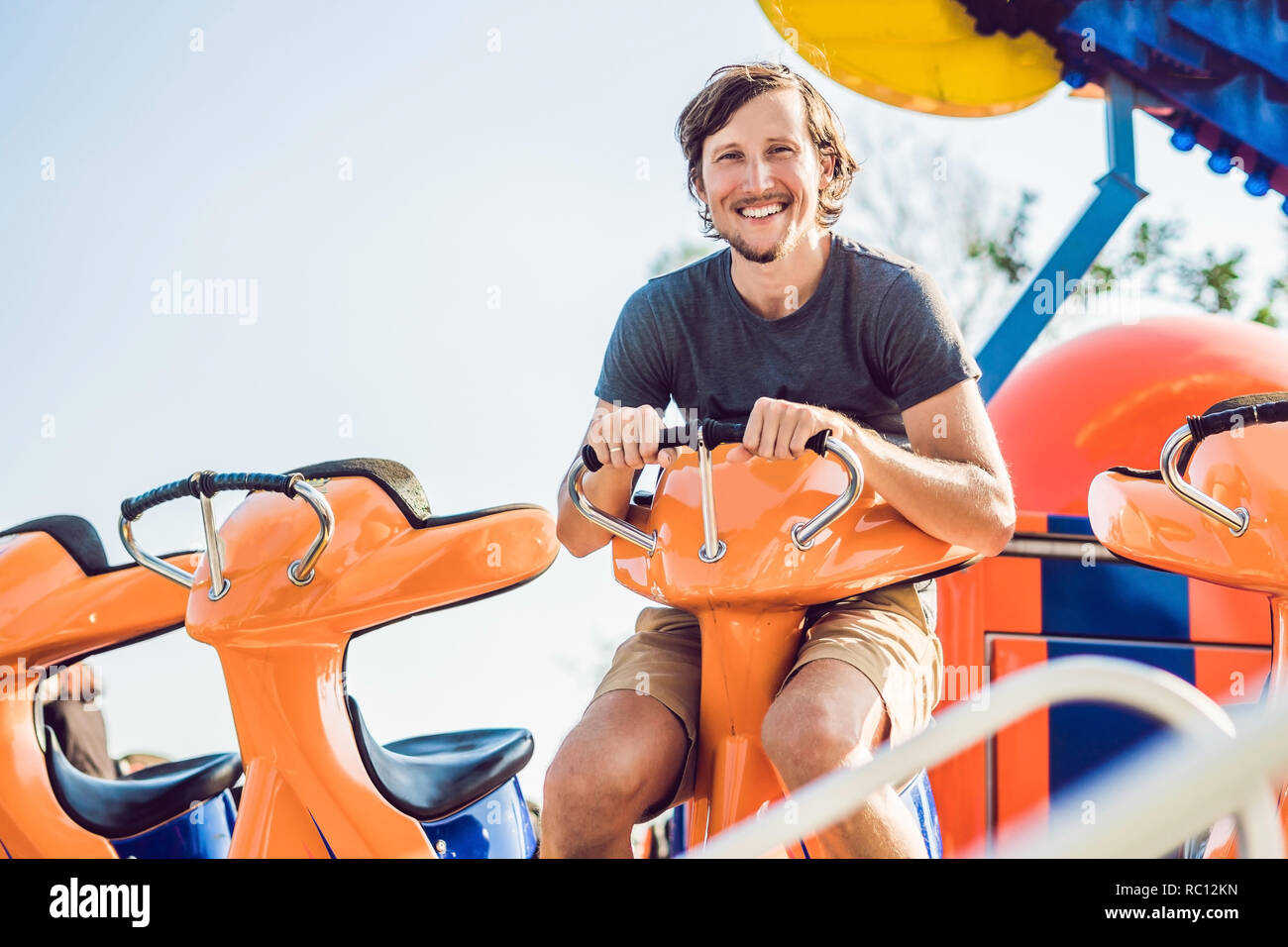Beautiful, young man having fun at an amusement park Stock Photo - Alamy