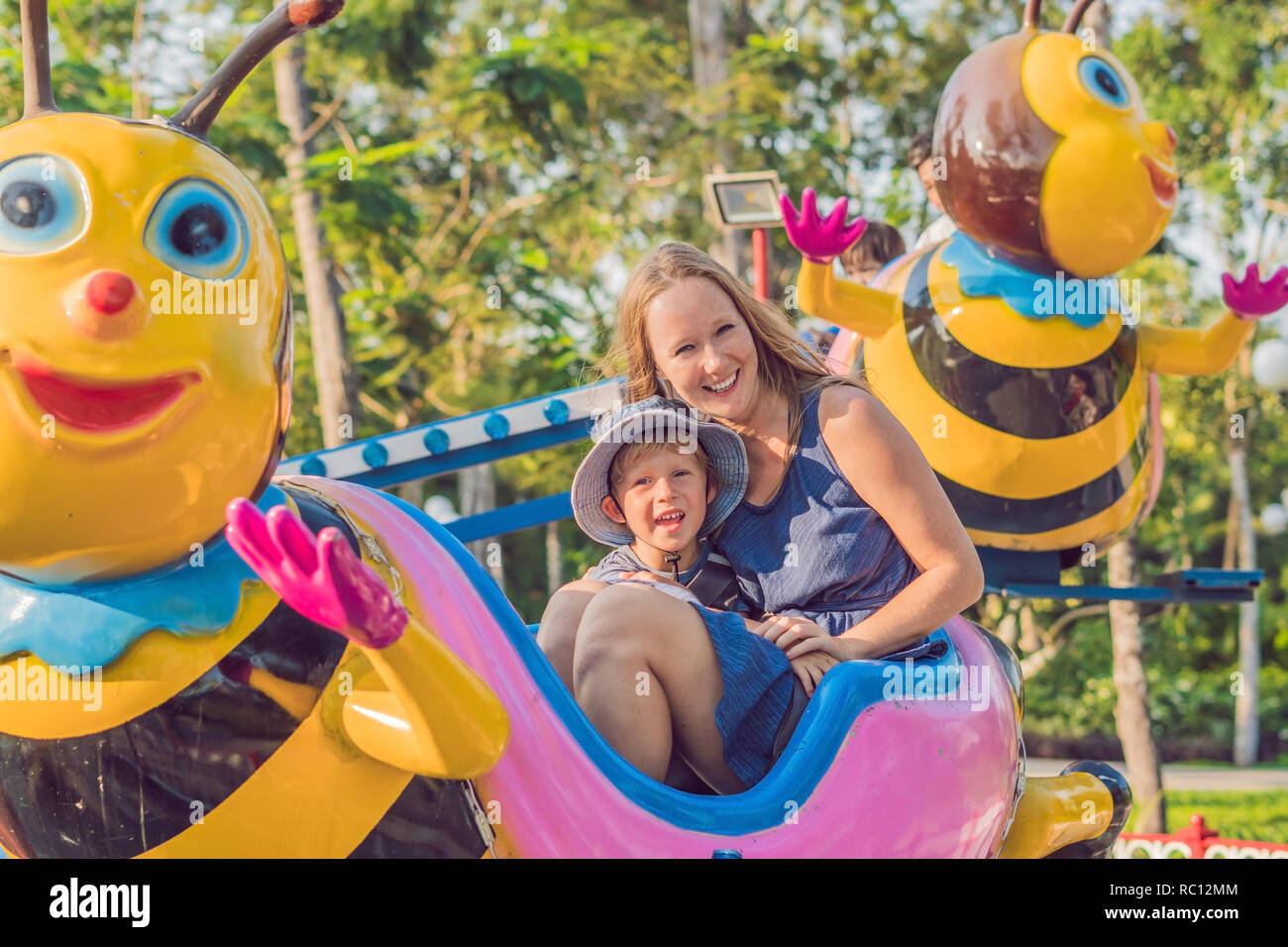Mom and son having fun at an amusement park Stock Photo - Alamy