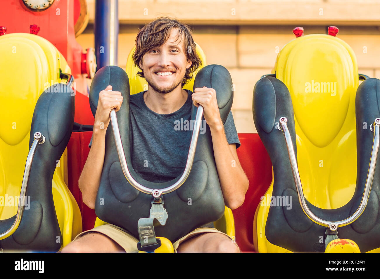 Beautiful, young man having fun at an amusement park Stock Photo - Alamy