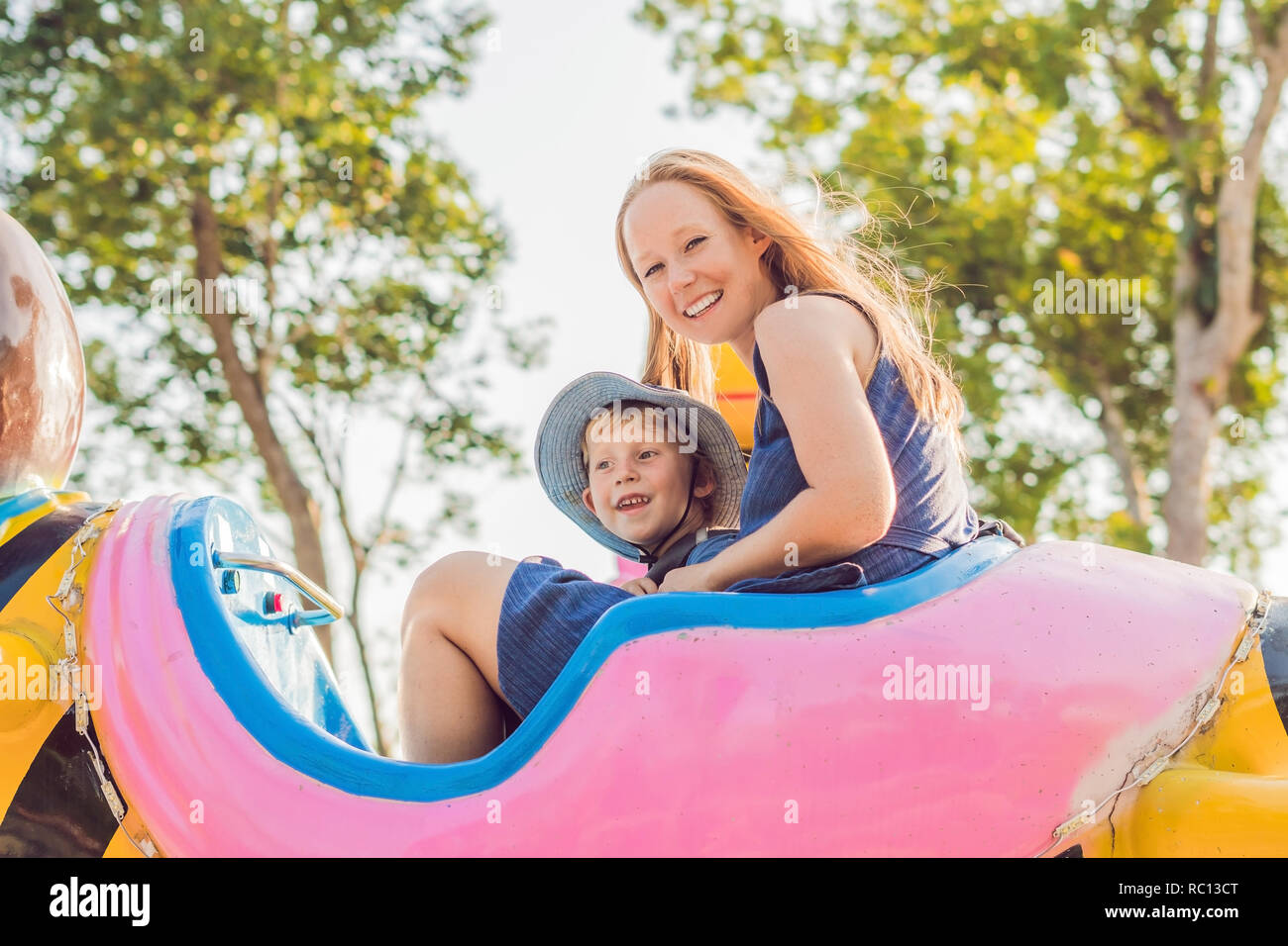 Mom and son having fun at an amusement park Stock Photo - Alamy