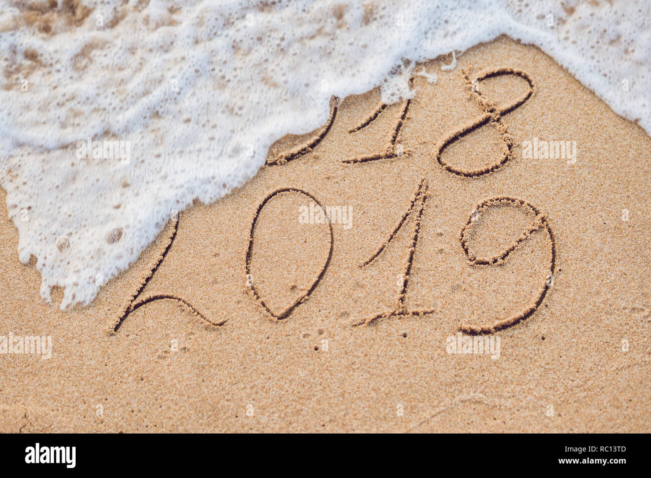 New Year 2019 is coming concept - inscription 2018 and 2019 on a beach ...