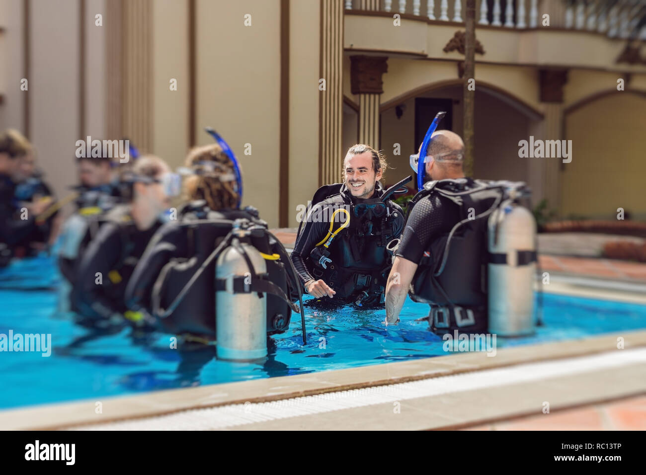 Diving instructor and students. Instructor teaches students to dive ...