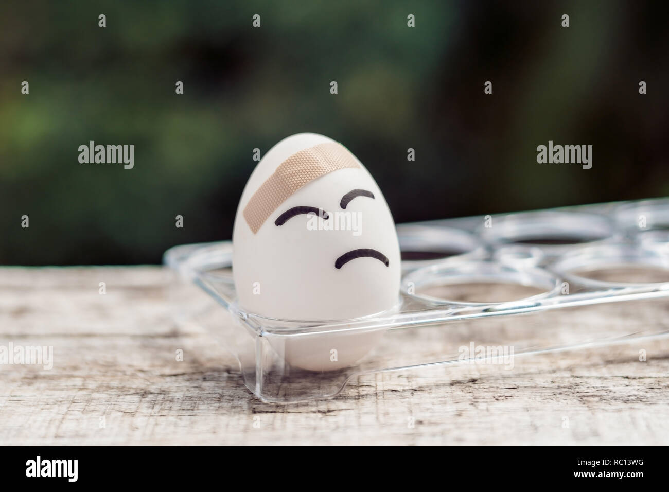 Broken egg with sticking plaster. Concept of brittleness and pain Stock ...