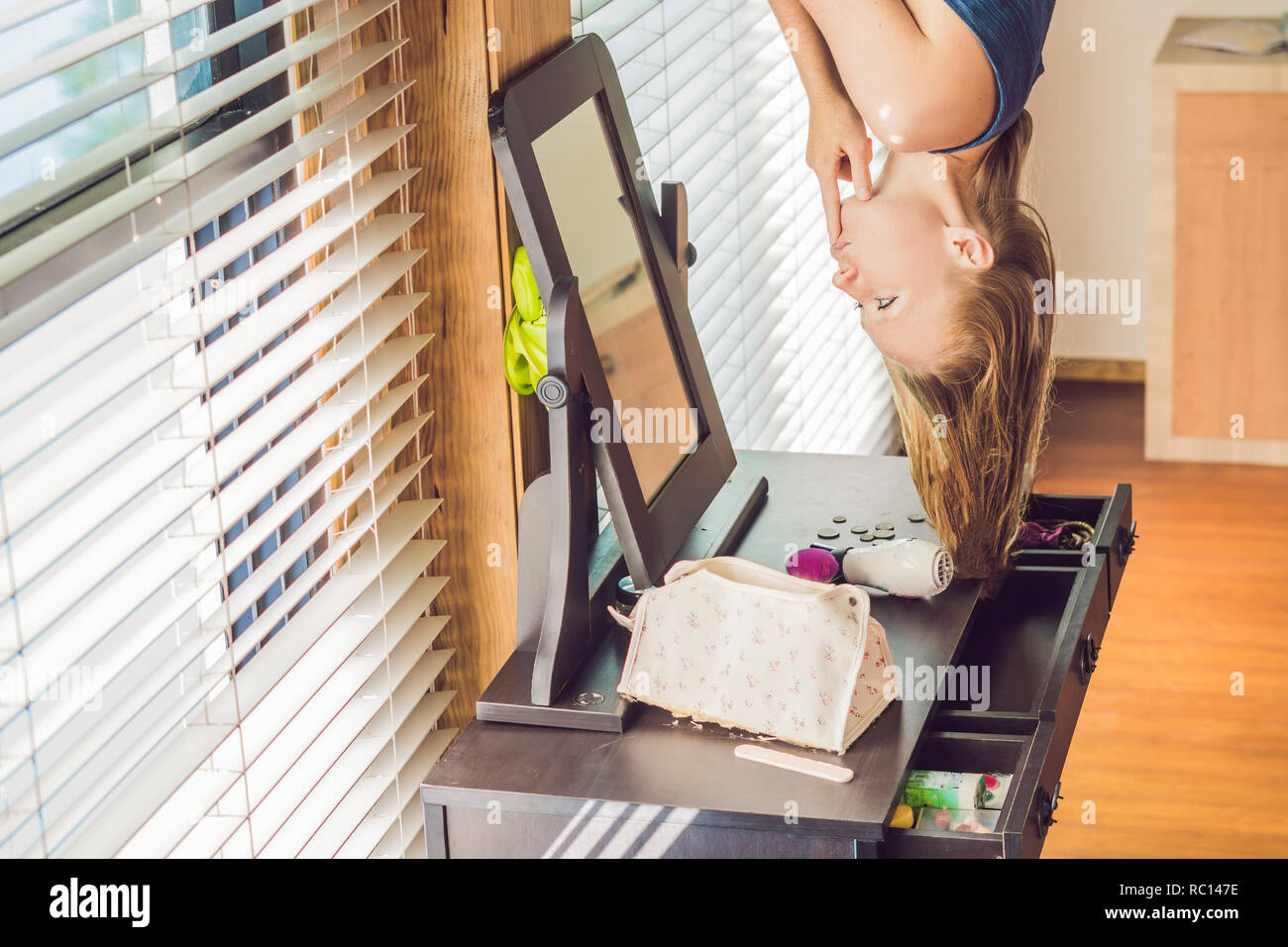 Woman upside down in the bedroom above the dressing table Stock Photo ...