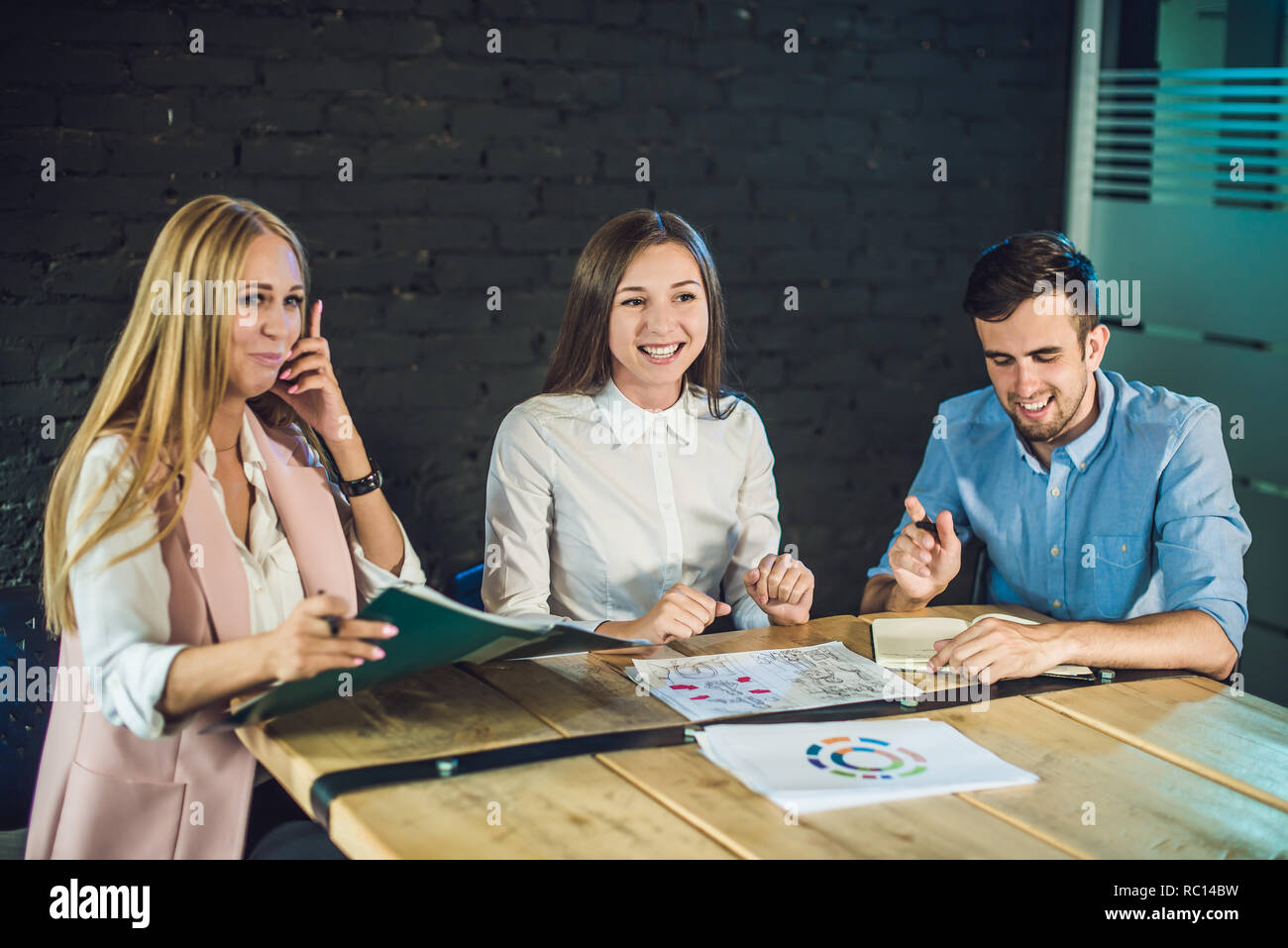 Young team of coworkers watching storyboard for shooting video in ...