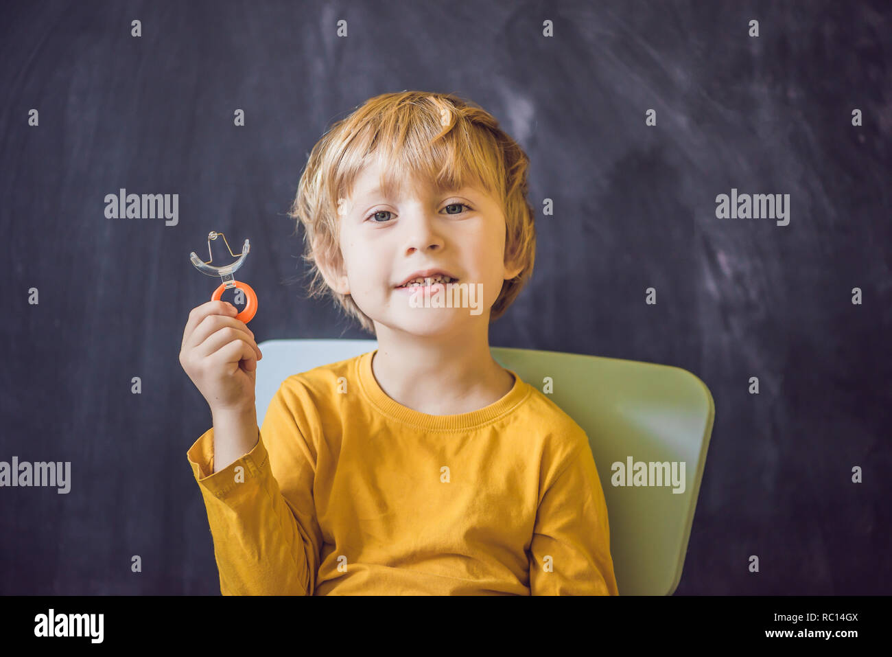 Three-year old boy shows vestibular plate. Plate with a bead to ...
