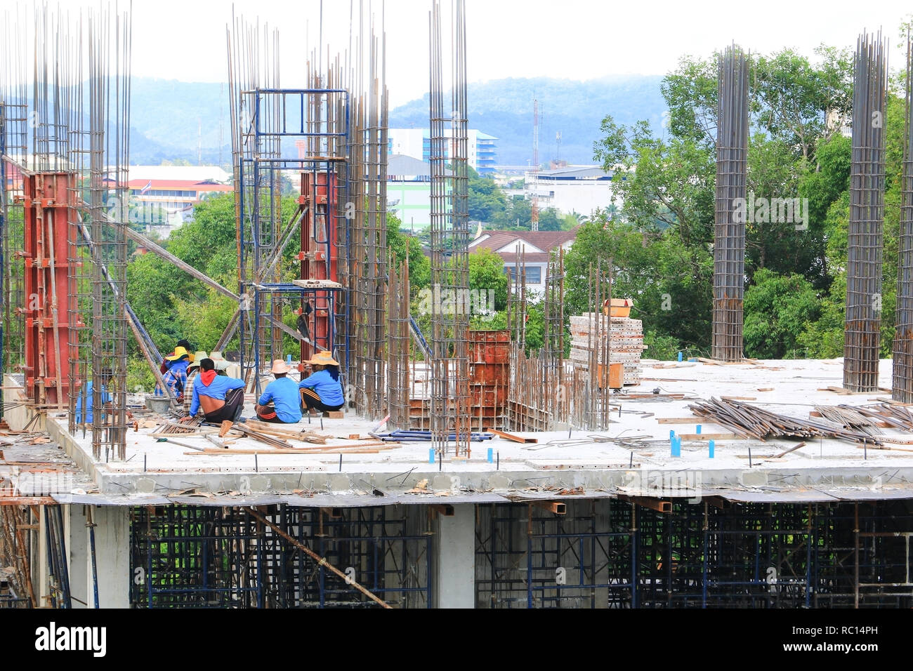 labor working in big construction site in develop city on white ...