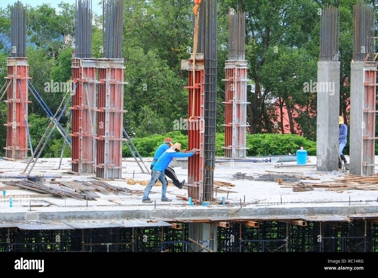 labor working and Crane hook in big construction site in develop city Stock Photo - Alamy