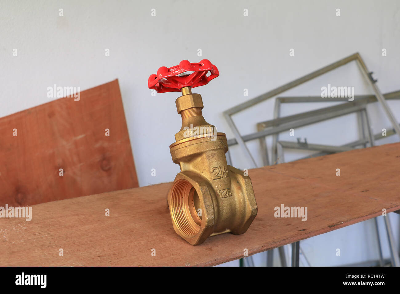 brass valve with red knob in a factory plumber on wooden floor ...