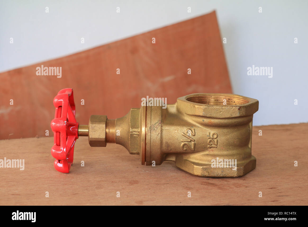 brass valve with red knob in a factory plumber on wooden floor ...