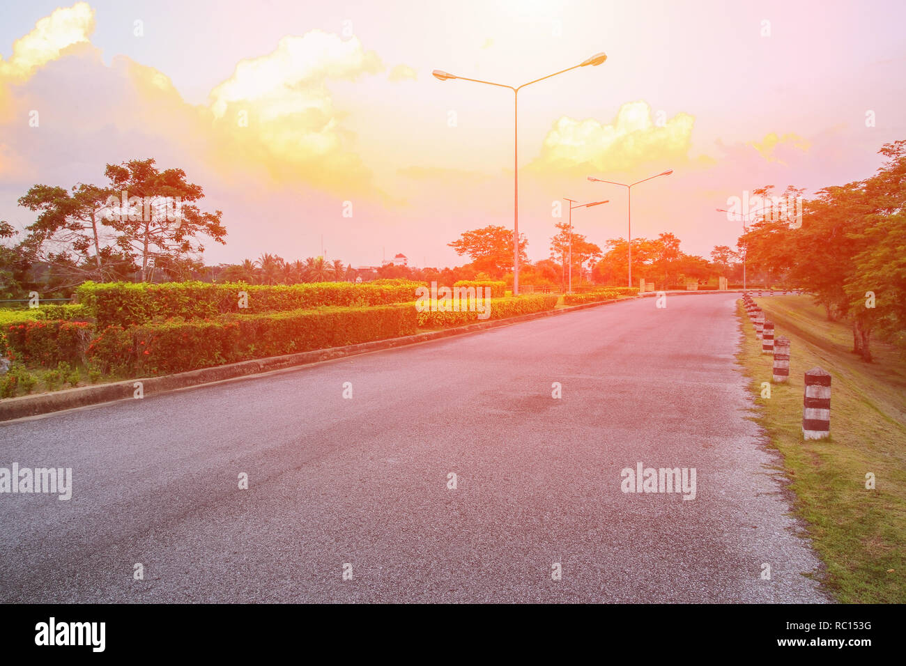 black and white painted milestone. in range roadside with sunset light ...