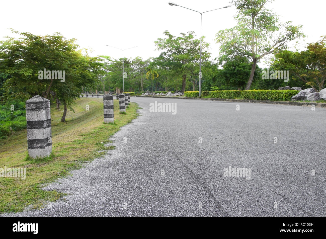 black and white painted milestone. in range roadside on white ...