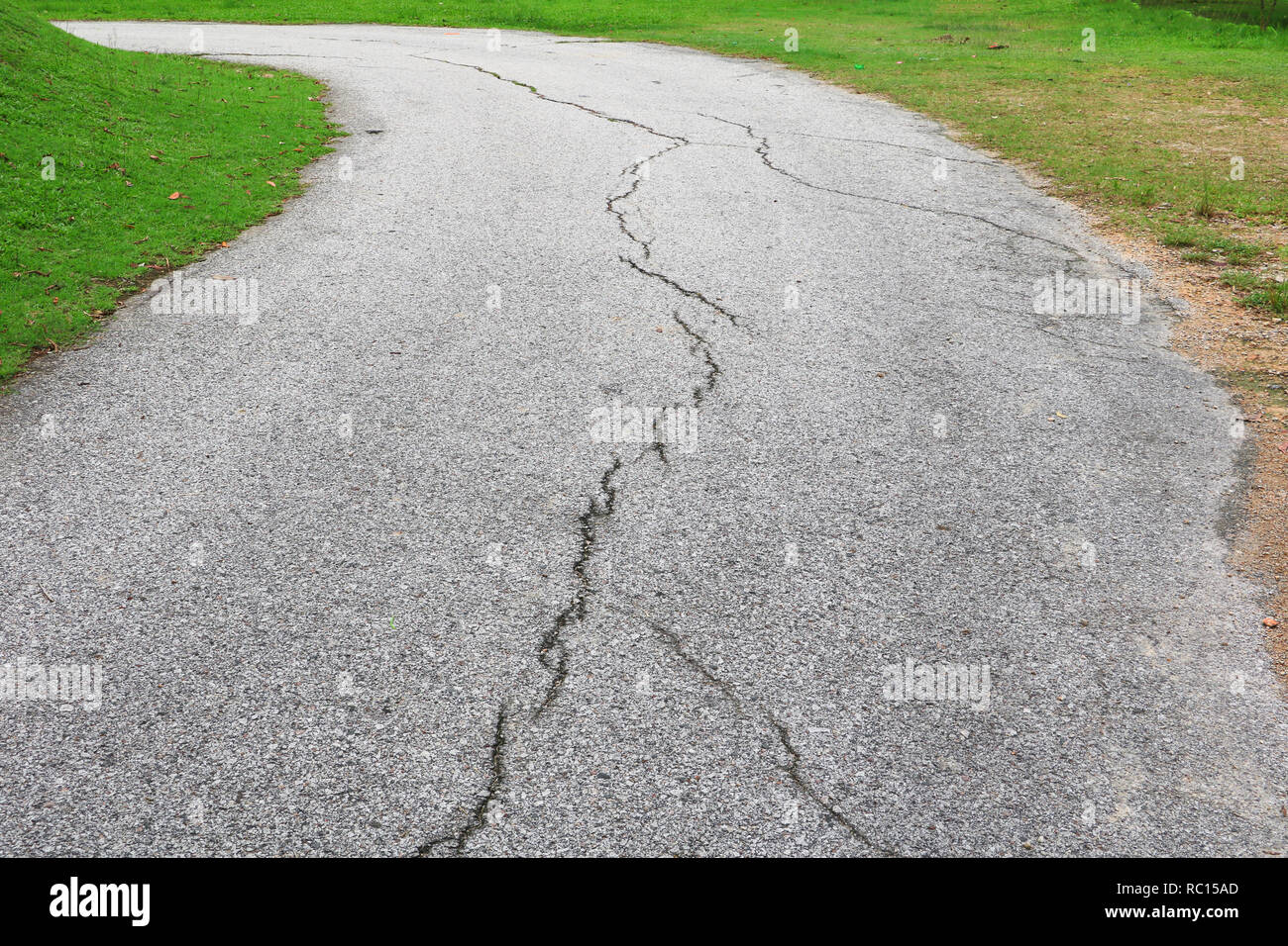 asphalt road cracked. street in public park Stock Photo - Alamy