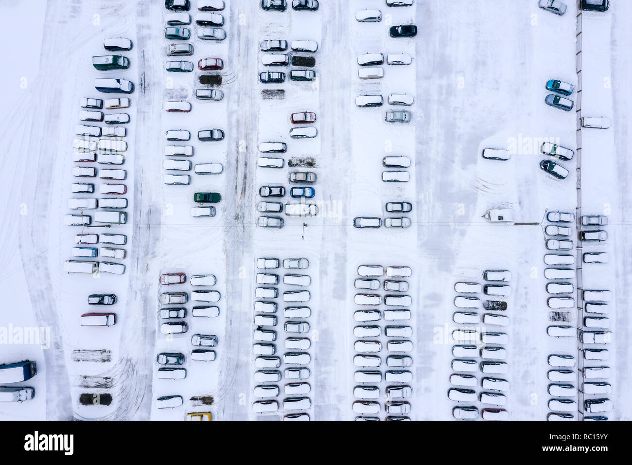 aerial view of urban parking lot covered with fresh snow in winter ...