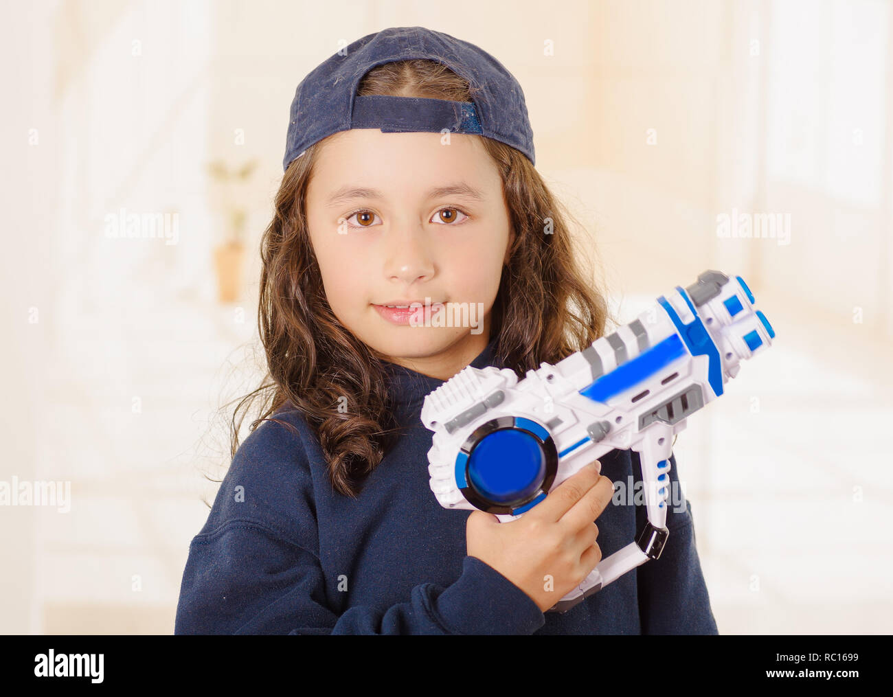 Girl playing with toy gun hi-res stock photography and images - Alamy