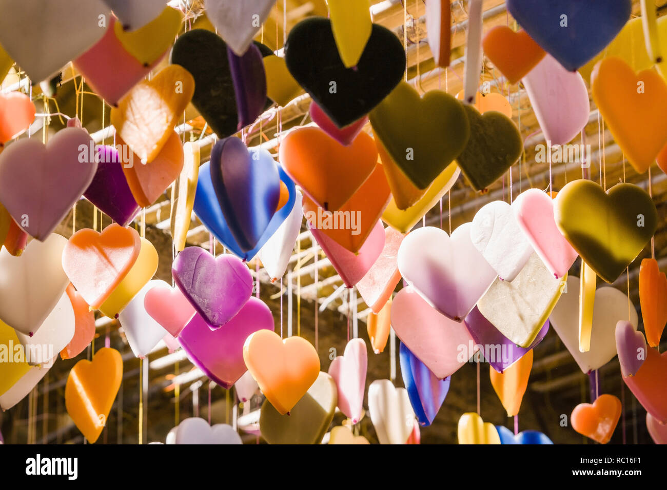 Colorful of hearts made of candle pattern designs hanging from ceiling ...