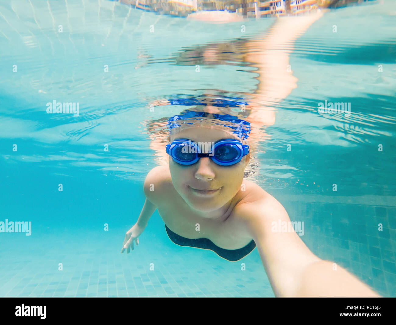Little baby learning to swim underwater in a swimming pool hi-res stock ...
