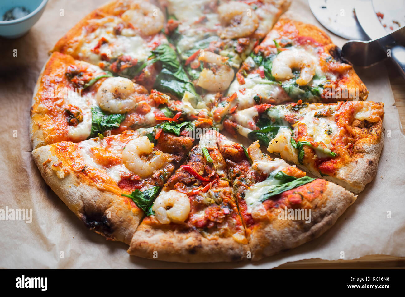 Garlic king prawn wood fired pizza with spinach & red chilli Stock ...