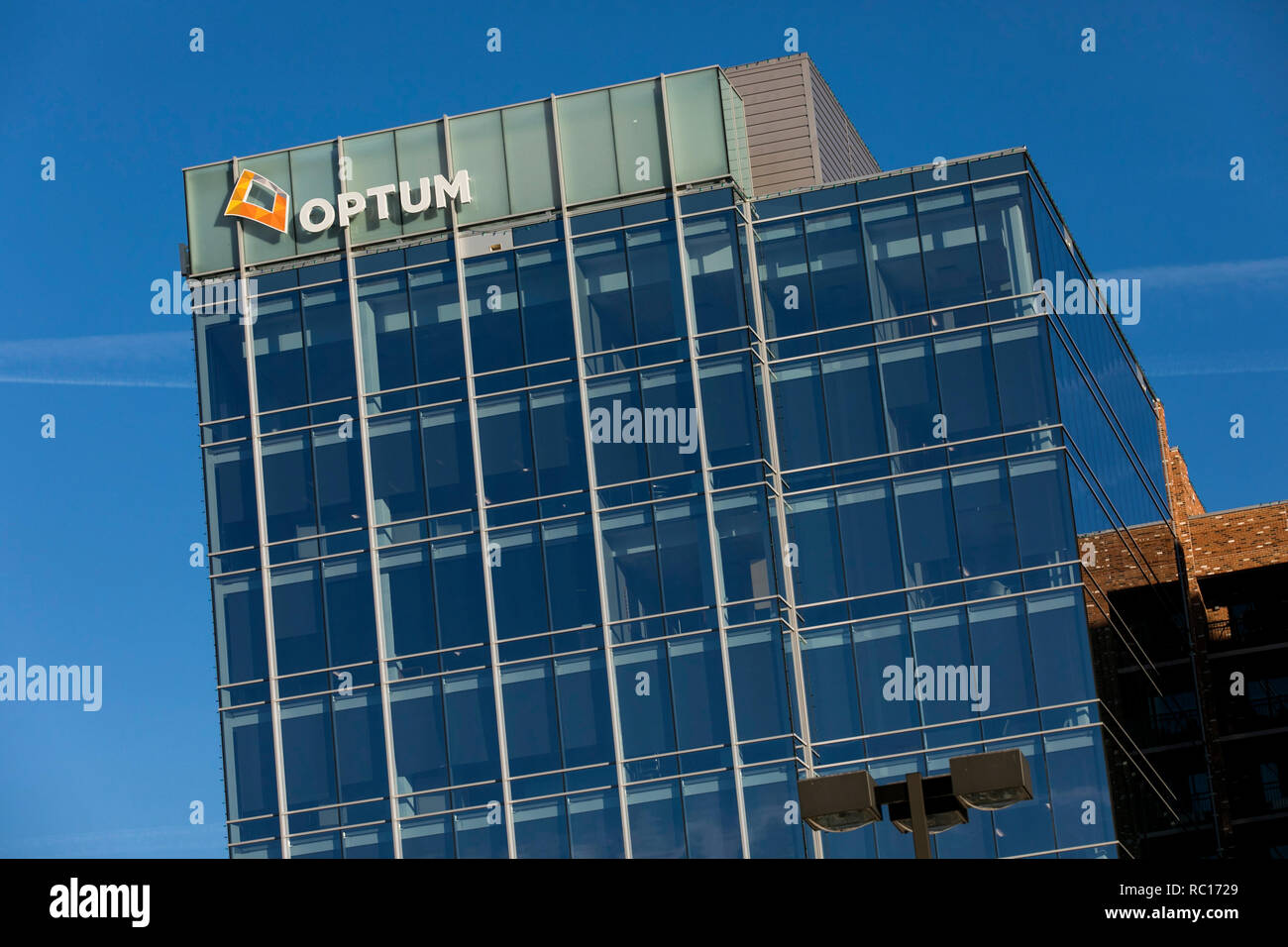 A logo sign outside of a facility occupied by Optum, in Columbia ...