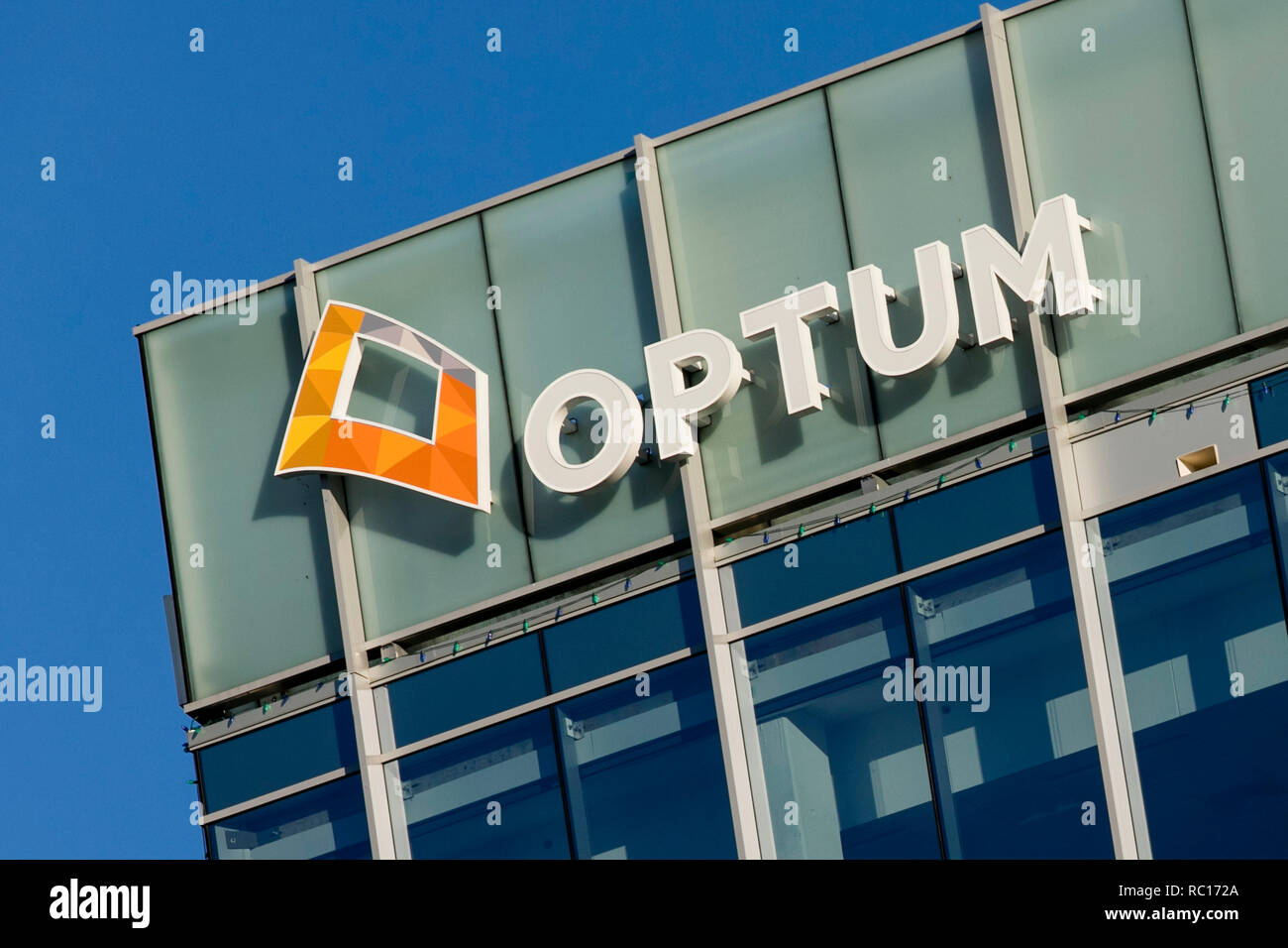 A logo sign outside of a facility occupied by Optum, in Columbia ...