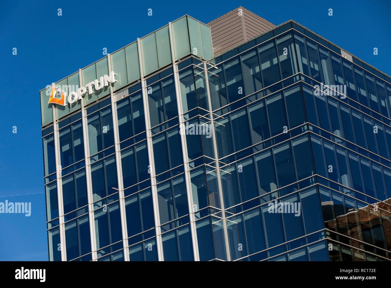 A logo sign outside of a facility occupied by Optum, in Columbia ...