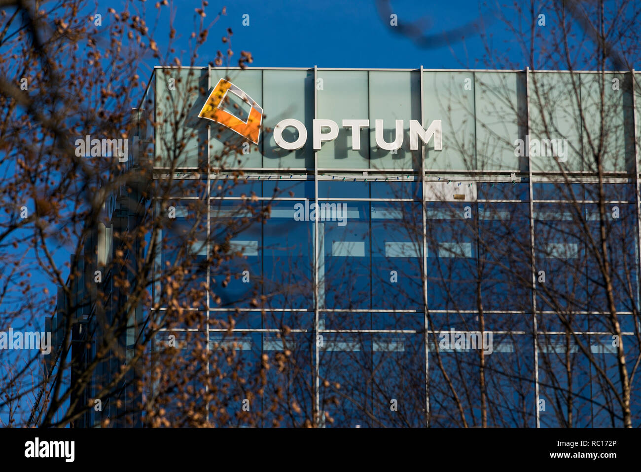 A logo sign outside of a facility occupied by Optum, in Columbia ...