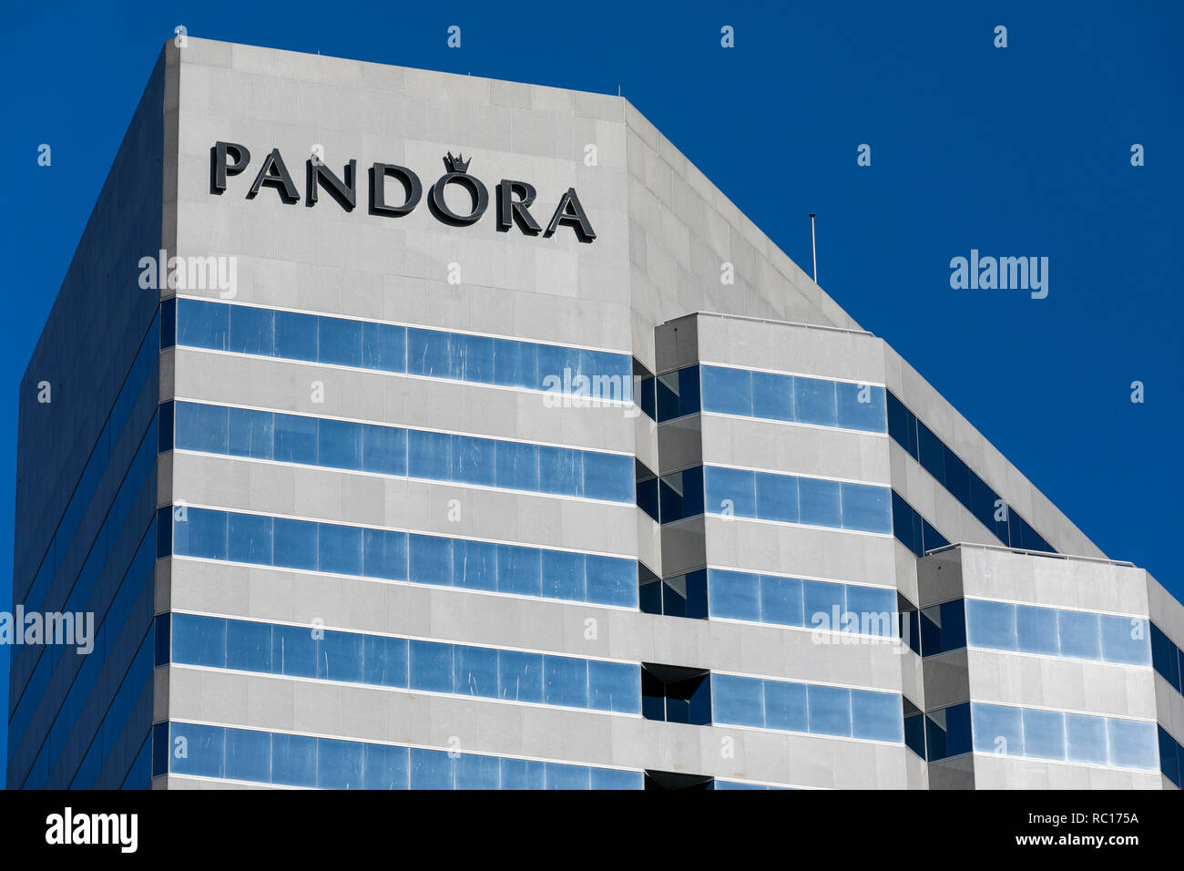 A logo sign outside of a facility occupied by Pandora Jewelry in ...